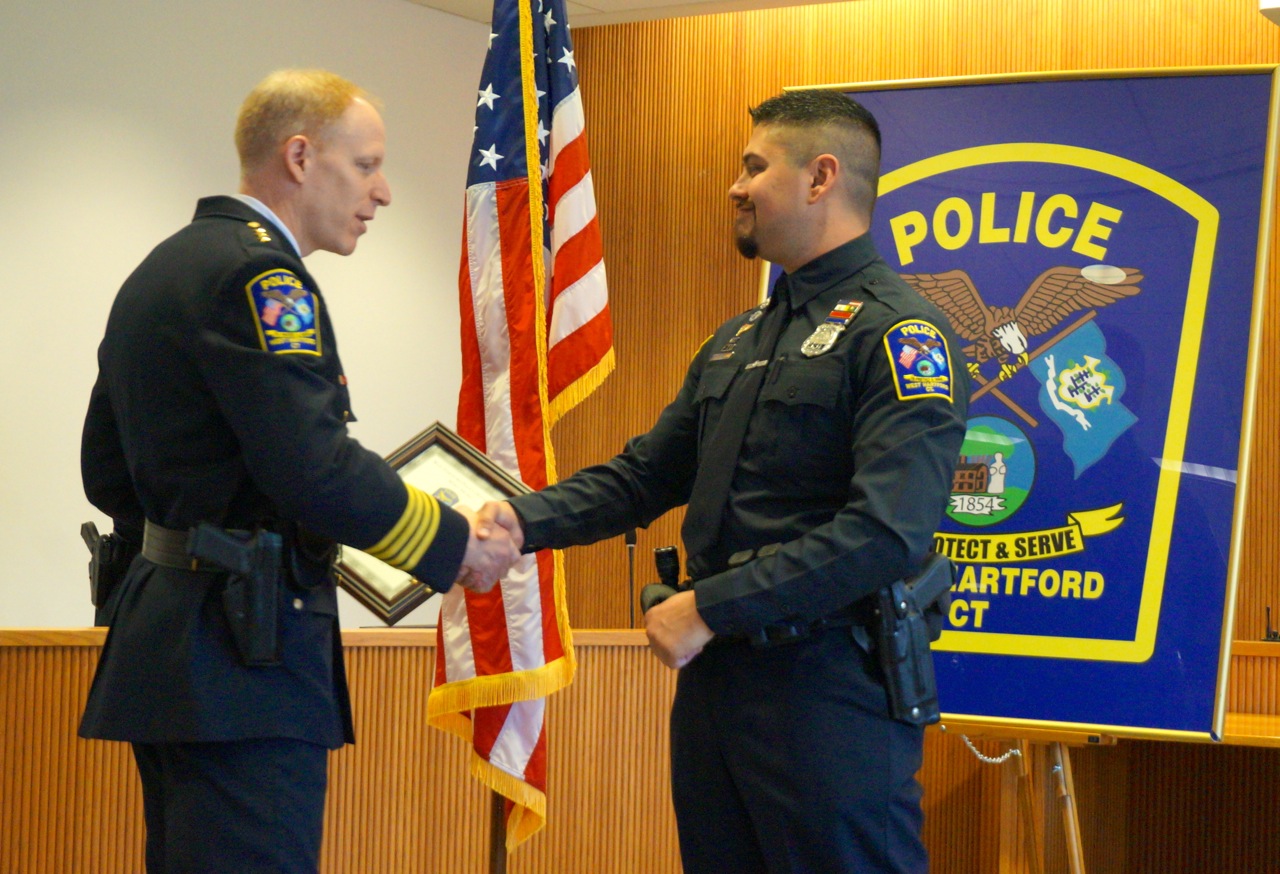 off. christopher tyler shakes chief tracey gove's hand after receiving ...