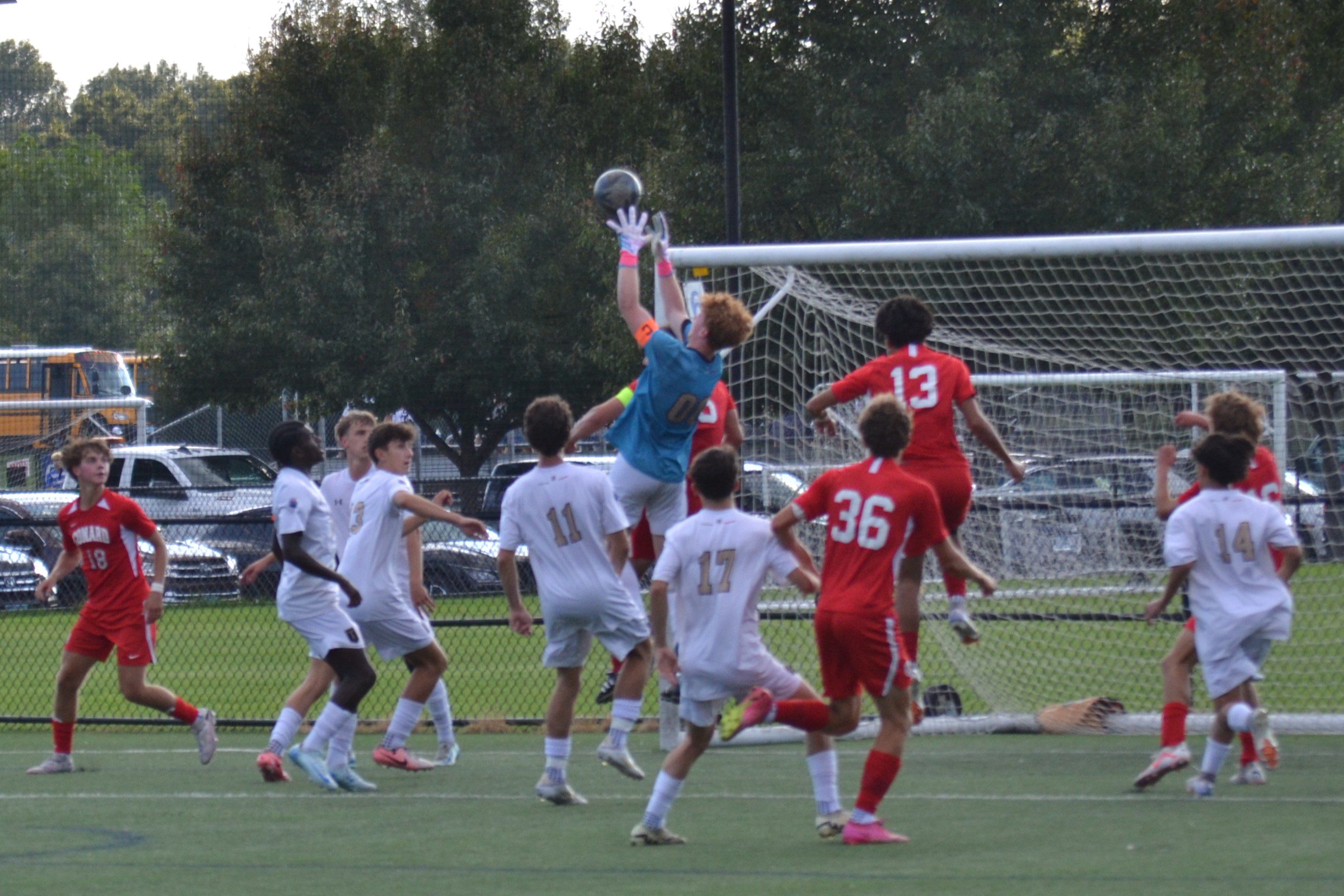 Trumbull goalie Connor Hughes goes up for the high ball from Conard ...